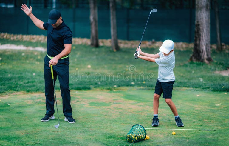 Golf Lesson. Golf Instructor Teaching Young Boy How To Swing Stock ...