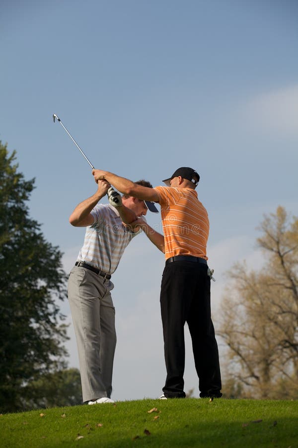 Golf Professional Helping Young Man with His Swing Stock Image - Image ...