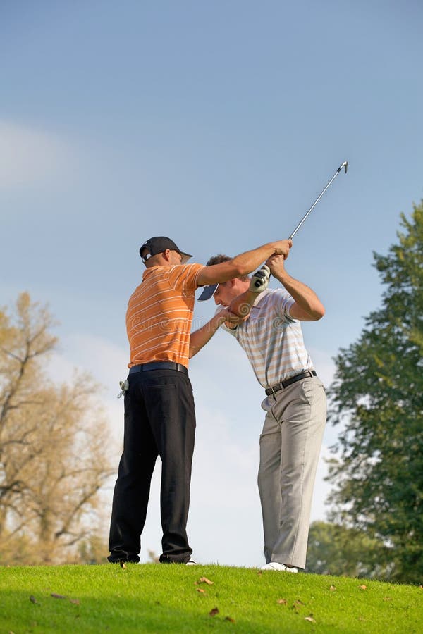 Golf Professional Helping Young Man with His Swing Stock Photo - Image ...