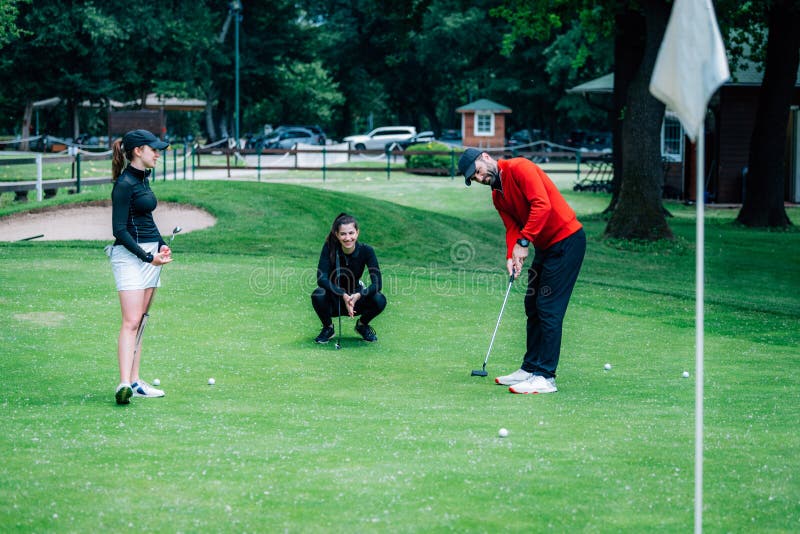 Golf Putting Lesson, Two Young Female Golfers Practicing Putting with ...