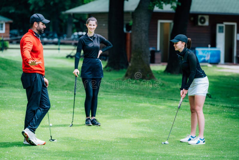 Golf Putting Lesson, Two Young Female Golfers Practicing Putting with ...