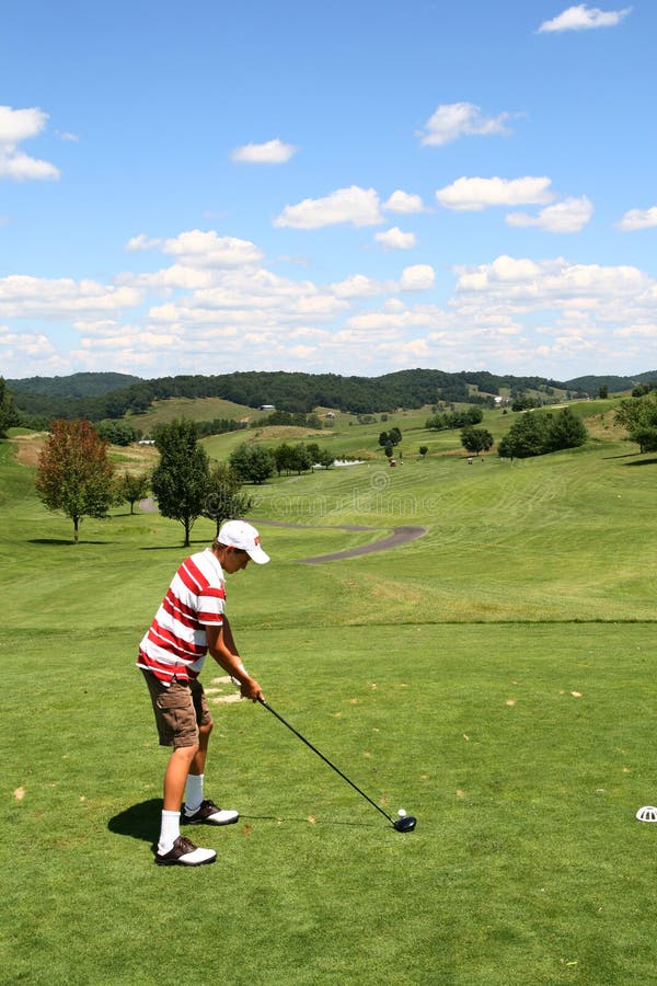 Golf - Young Man Teeing Off Stock Photo - Image of greens, teenager ...
