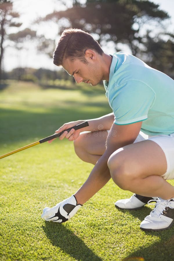 Golfer Man Placing Golf Ball on Tee Stock Photo - Image of outdoors ...