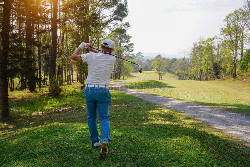 Golfer Playing Golf in the Evening Golf Course, on Sun Set Evening Time ...