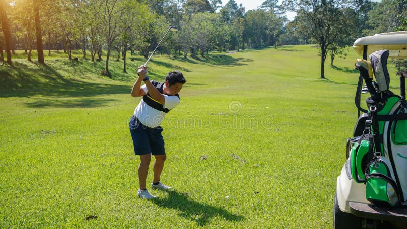 Golfer Playing Golf in the Evening Golf Course, on Sun Set Evening Time ...