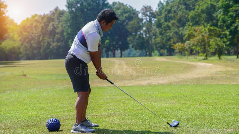 Golfer Playing Golf in the Evening Golf Course, on Sun Set Evening Time ...