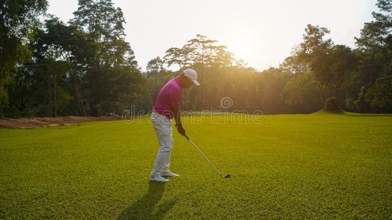 Golfer Playing Golf in the Evening Golf Course, on Sun Set Evening Time ...