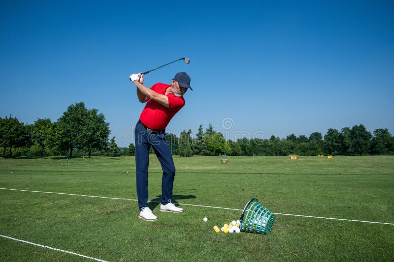Golfer Practicing Swing on Driving Range with Golf Balls and Basket ...