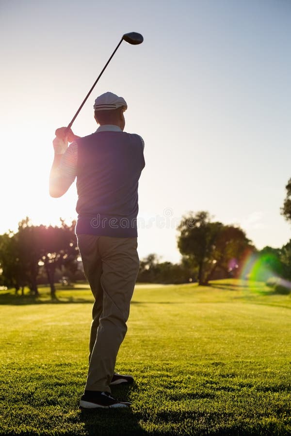 Golfer Teeing Off for the Day Stock Image - Image of sunlight, male ...