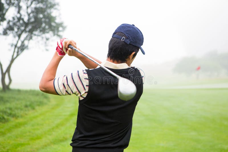 Golfer teeing off stock photo. Image of focused, activities - 50484144