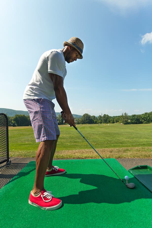 Golfer Teeing Up at the Driving Range Stock Photo - Image of action ...