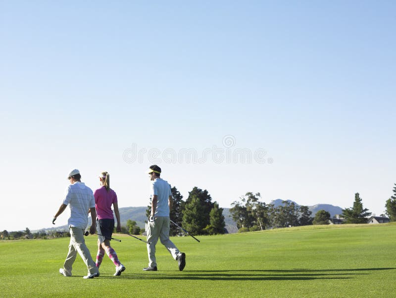 Golfers Walking on Golf Course Stock Photo - Image of golfing, rear ...