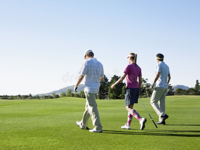 Golfers Walking on Golf Course Stock Photo - Image of golfing, rear ...