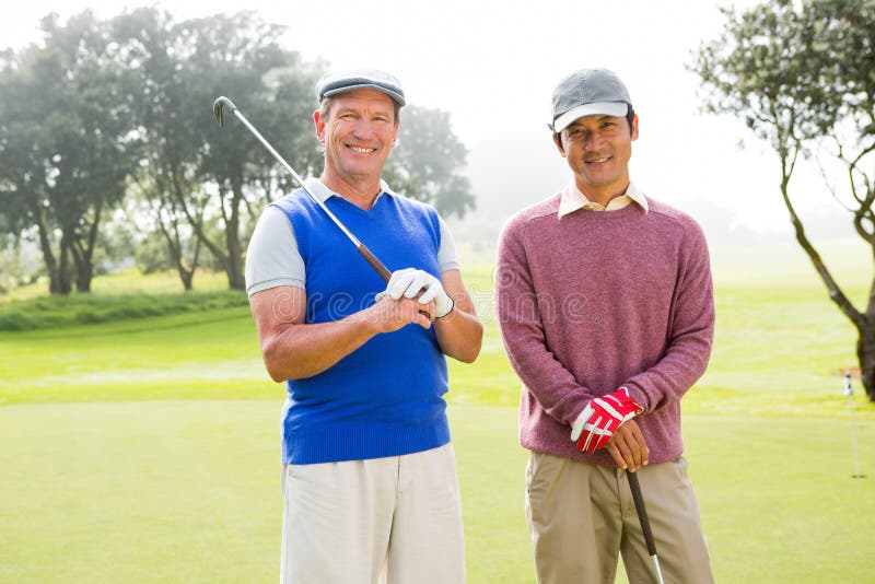 Golfing Friends Smiling at Camera Holding Clubs Stock Photo - Image of ...