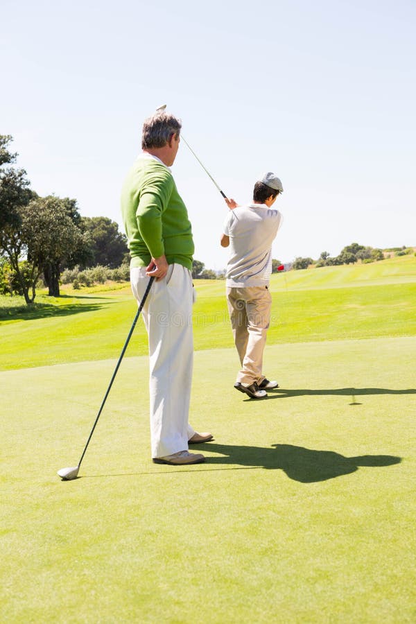 Golfing friends teeing off stock photo. Image of lifestyle - 50483858