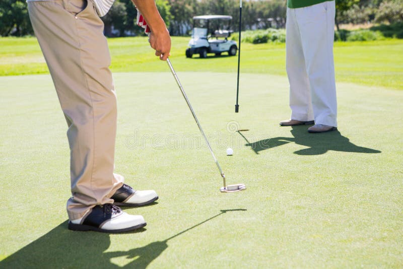 Golfing friends teeing off stock image. Image of golfer - 50486439