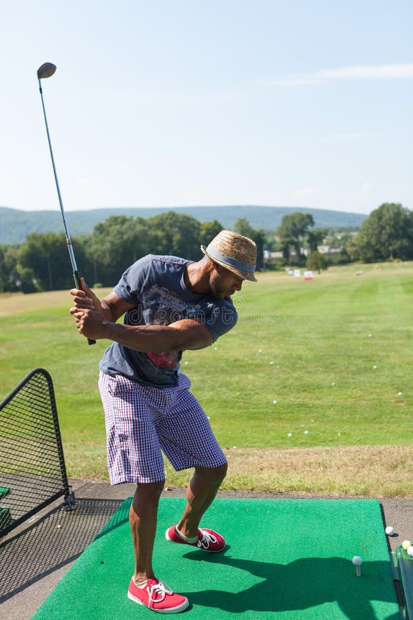 Golfing at the Range stock photo. Image of casual, grass - 49625624