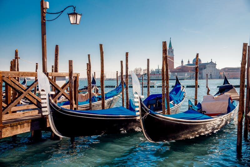 Gondolier Carries Tourists On Gondola Grand Canal Of Venice Italy