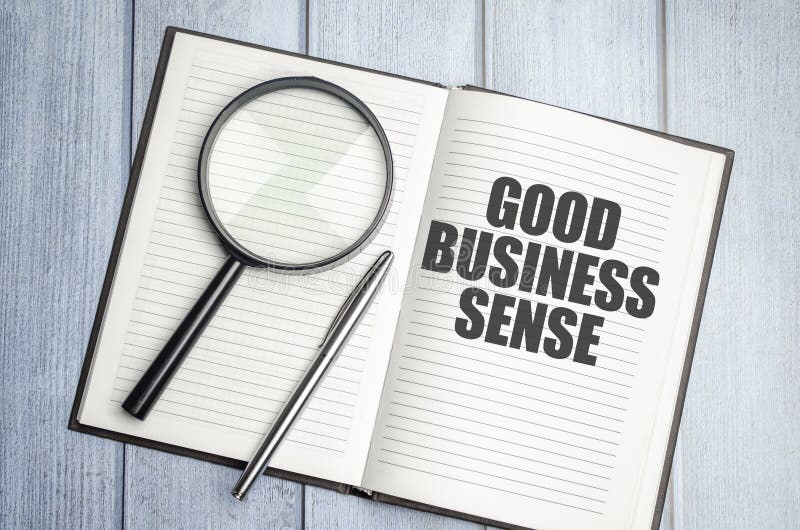 GOOD BUSINESS SENSE Text with Magnifier on the Brown Diary Stock Image ...