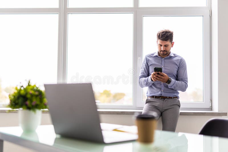 Good Business Talk. Handsome Young Man Use Phone and Using Computer ...