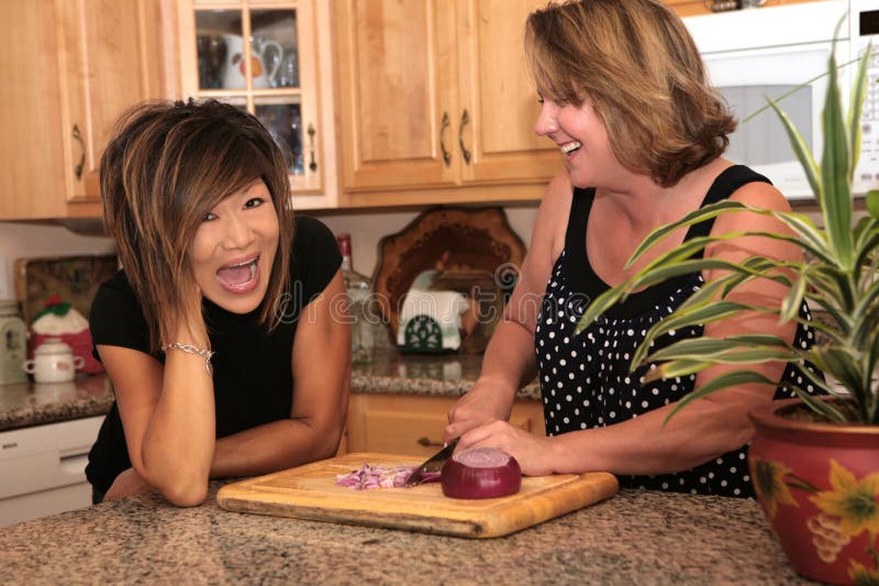 Good Gossip in the Kitchen stock photo. Image of asian - 6198480