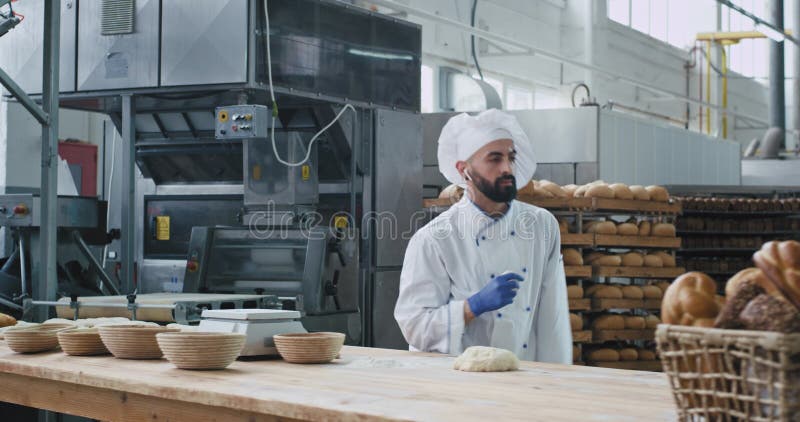 Good Looking Baker Very Funny at His Work in a Big Bakery Industry ...