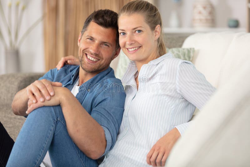 Good Looking Couple Relaxing on Their Couch at Home Stock Photo - Image ...