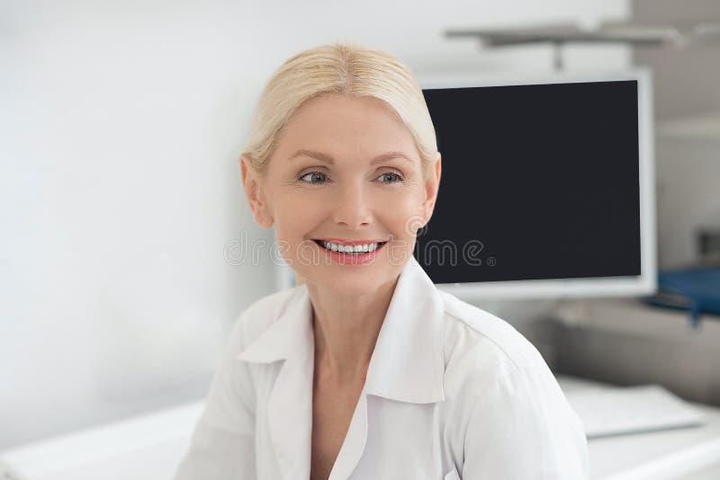 A Good-looking Female Doctor Smiling Nicely Stock Image - Image of ...