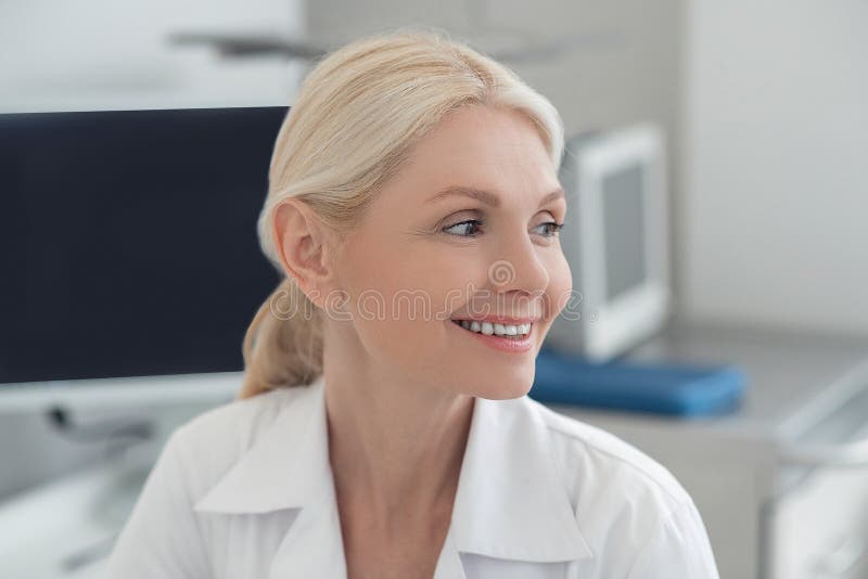 A Good-looking Female Doctor Smiling Nicely Stock Image - Image of ...