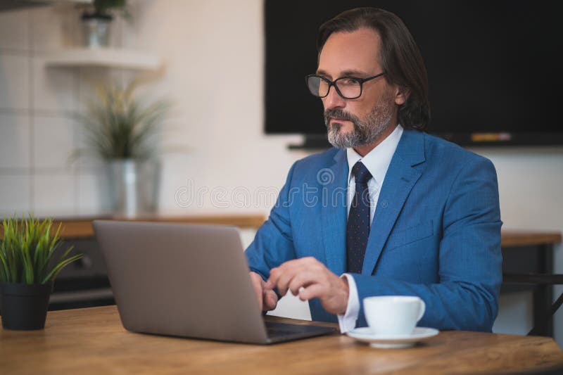 Good-looking Intelligent Man in Eyeglasses Working on Laptop Stock ...