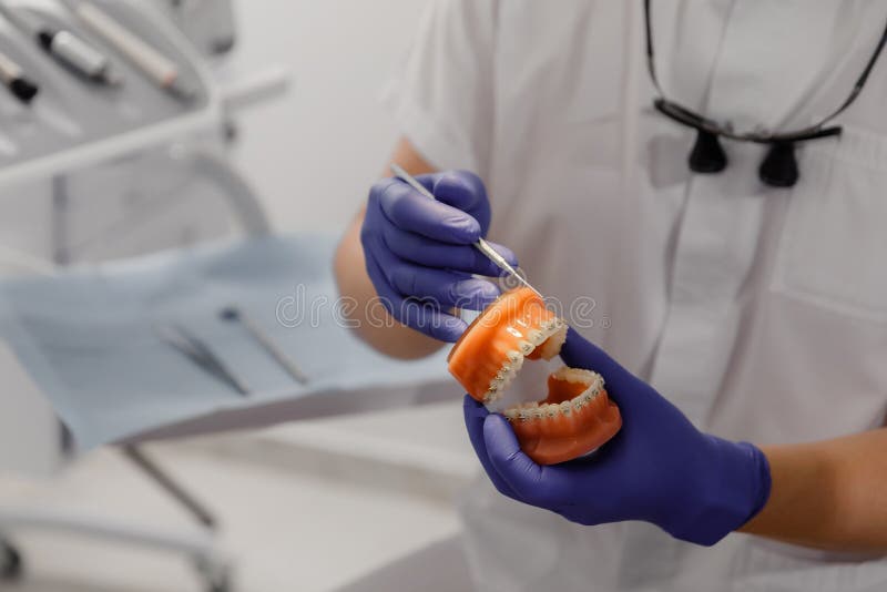 Good Looking Man Dentist with Protective Mask Explains To the Patient ...