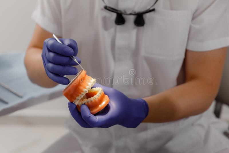 Good Looking Man Dentist with Protective Mask Explains To the Patient ...
