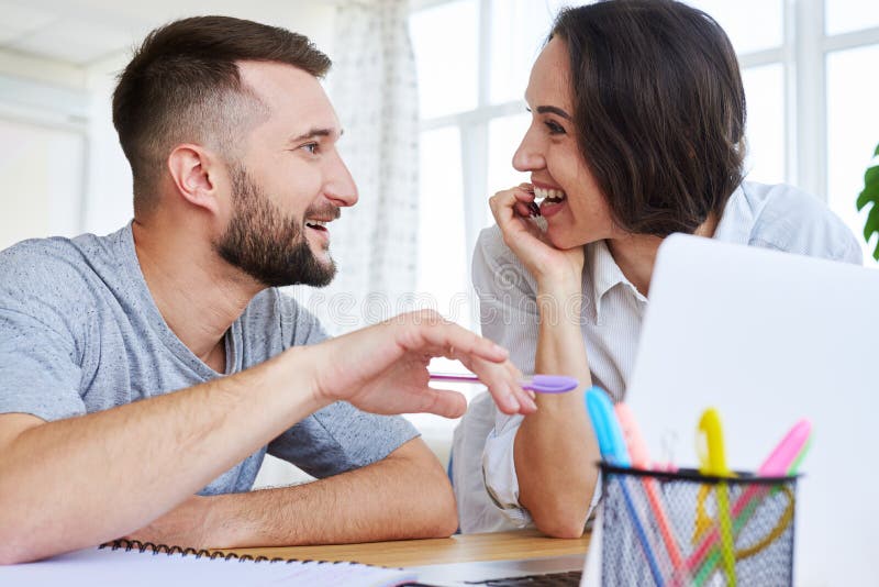 Good-looking pair looking at each other while discussing something ...