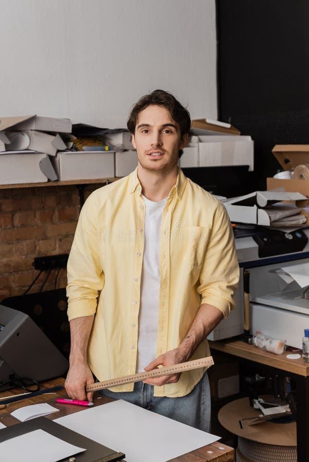 Good Looking Printing Operator Holding Ruler Stock Image - Image of ...