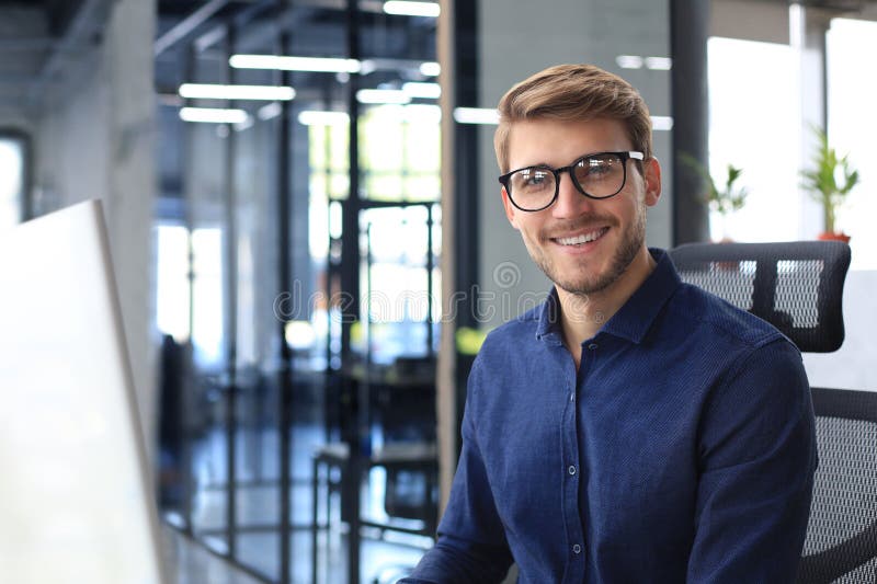 Good Looking Young Business Man Looking at Camera and Smiling while ...