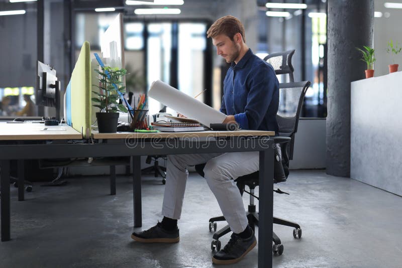 Good Looking Young Business Man Drawing Something while Working in the ...