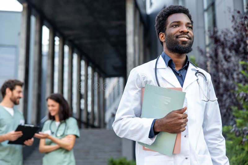 Good-looking Young Dark-skinned Doctor in a Lab Coat Looking Confident ...