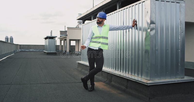 Good Looking Young Engineer or Architect with a Safety Helmet on the ...