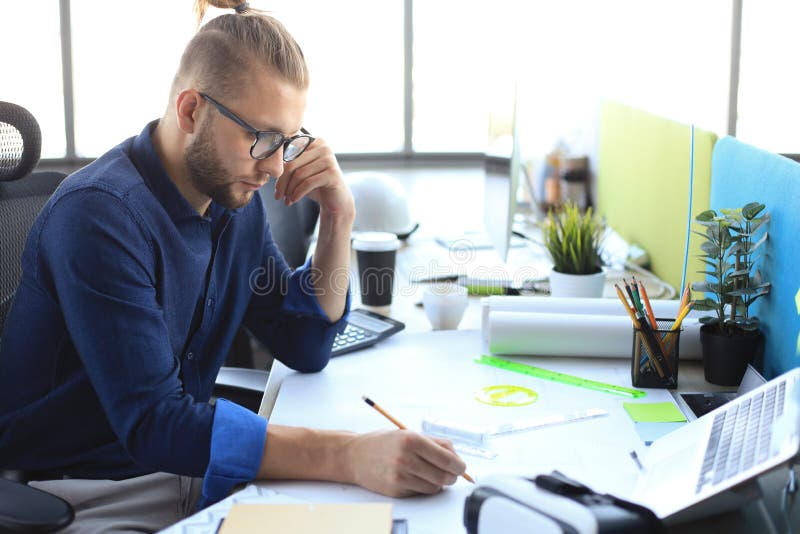 Good Looking Mature Architect Drawing Something while Working in the ...