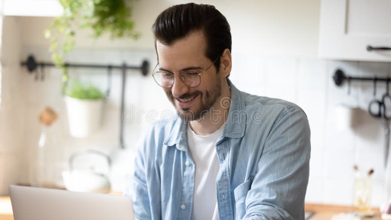 Happy Smiling Young Man Chatting Online Using Laptop at Kitchen Stock ...