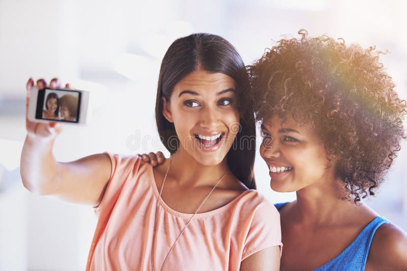 Good Times Together Two Girlfriends Taking A Selfie On A Mobile Phone