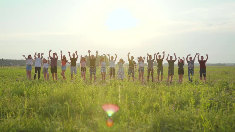 Goodbye Concept. a Large Group of Students Wave Their Hands at Sunset ...