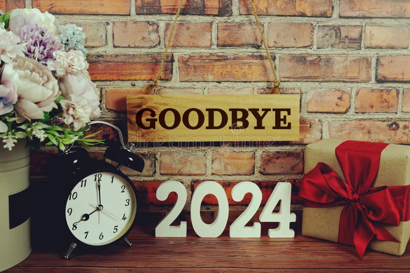 Goodbye 2024 Letters with Alarm Clock and Gift Box on Wooden Background ...