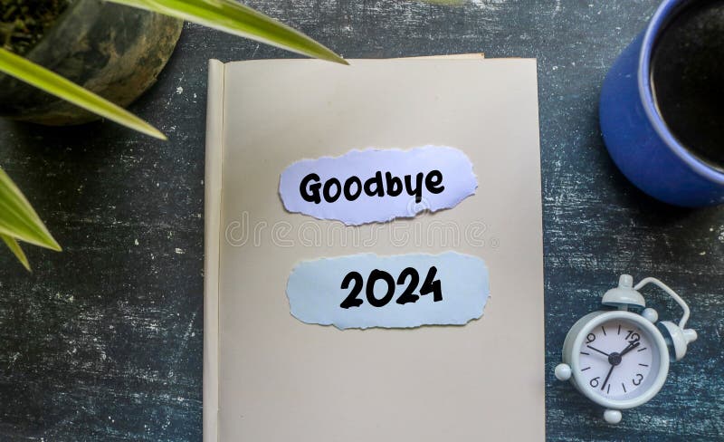 Goodbye 2024 Text in Notebook with Alarm Clock on Wooden Table Stock ...