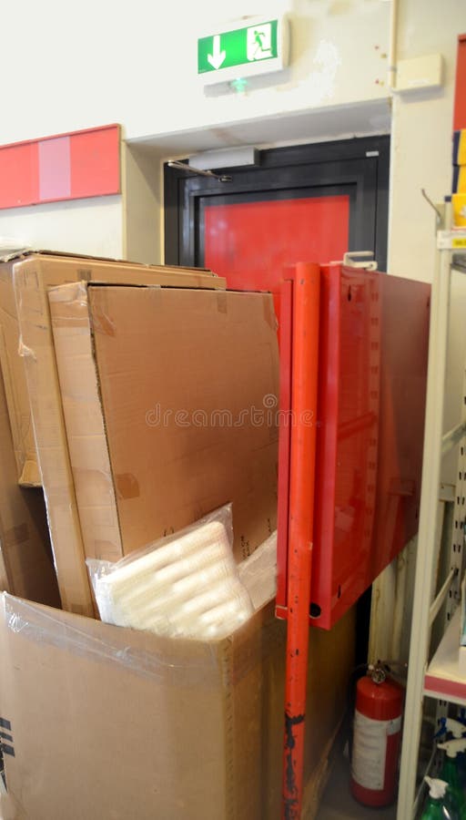 Blocked Fire Exit and Fire Hose Stock Photo - Image of ignorant, goods ...