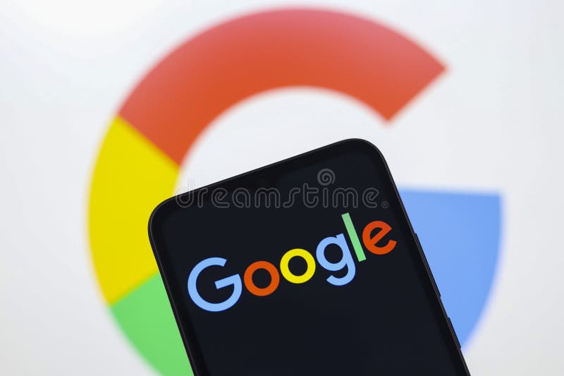 The Google Logo is Displayed on a Smartphone Screen and on the Computer ...