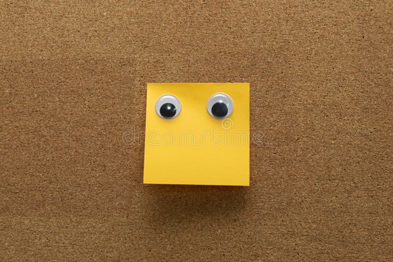 Googly Eyes on Clean Orange Sticky Note on Cork Board Concept Using ...