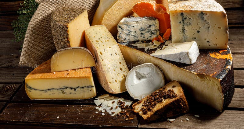 A Gorgeous Artisanal Cheese Selection Artfully Arranged on a Rustic ...