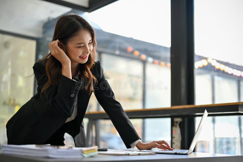 Gorgeous Asian Business Leaning on Table, Using Laptop Computer ...