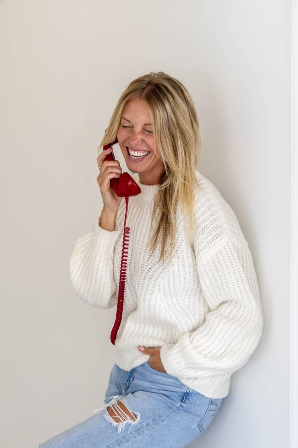 A Gorgeous Blonde Model Talks on the Phone Showing Emotion in a Home ...